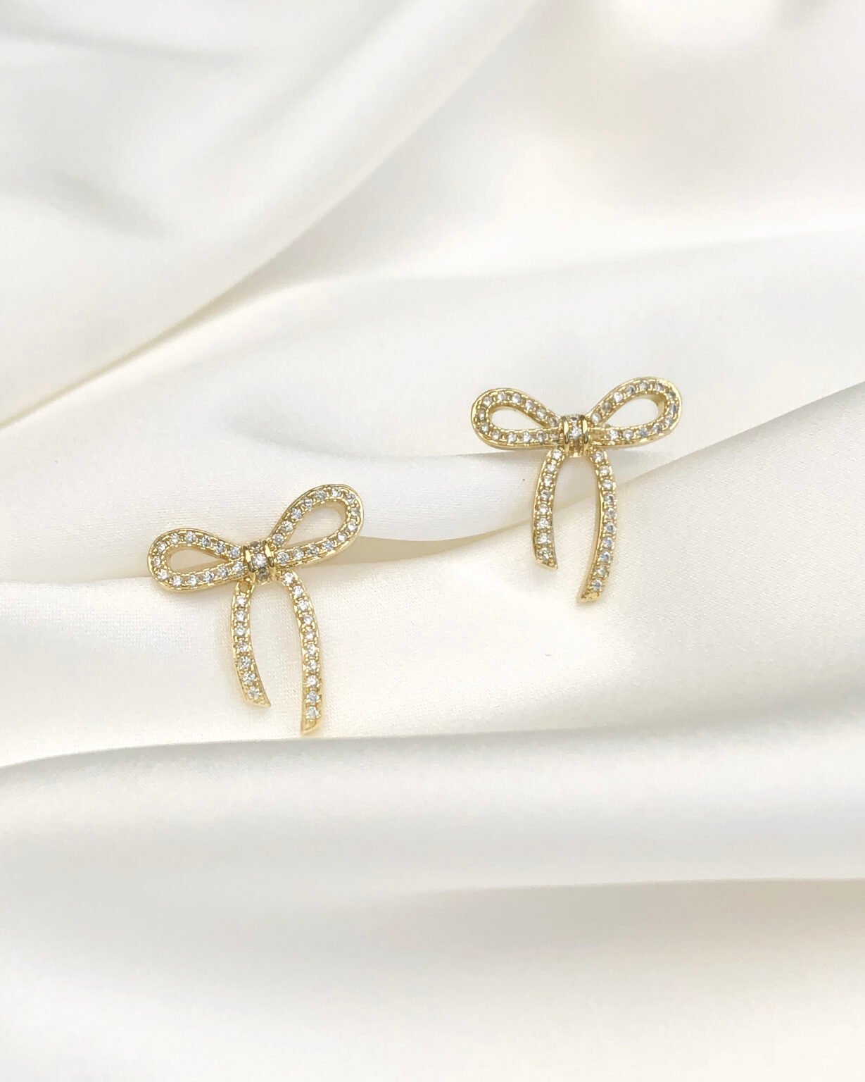 Gold fashion earrings bow shape with zirconium crystals